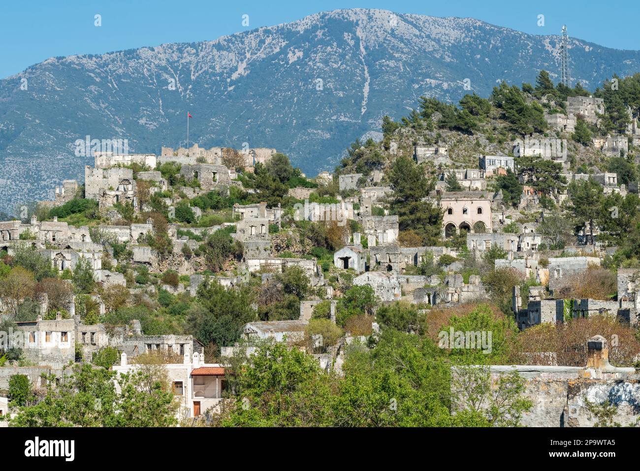 View over the ruined houses of Kayakoy (Levissi) abandoned village near ...