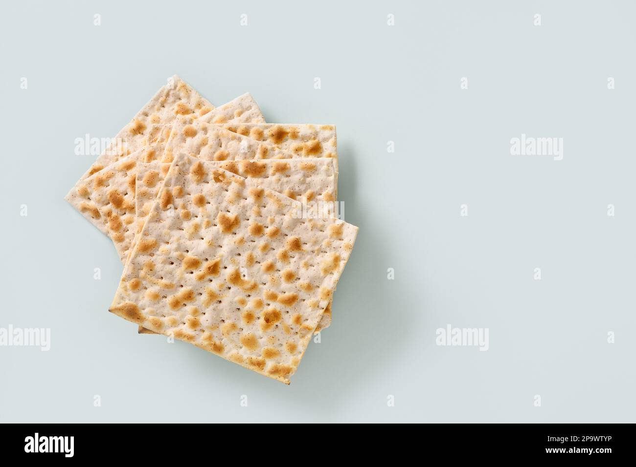 Traditional Jewish kosher matzo for Passover isolated on blue ...