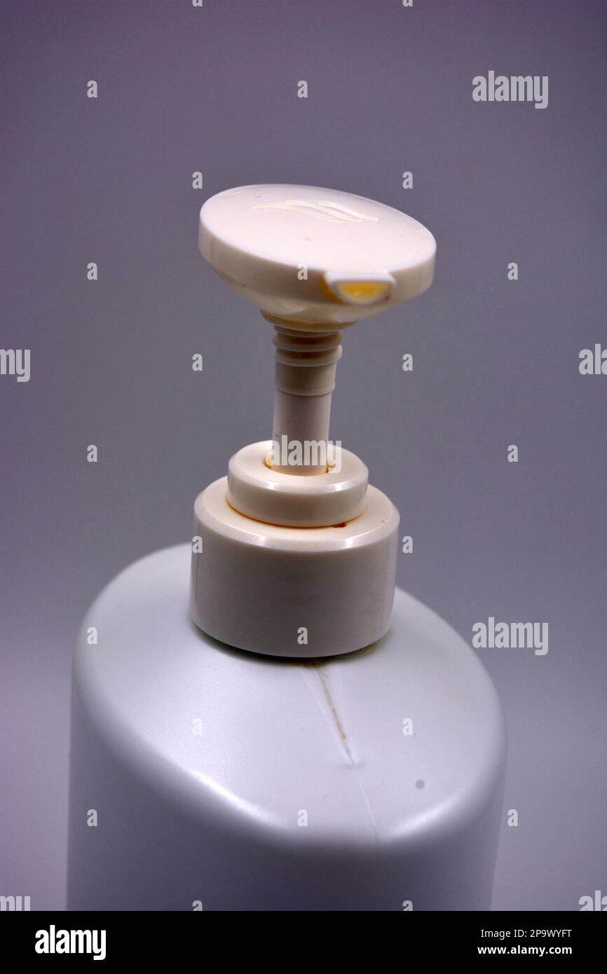 A large white plastic bottle with a large dispenser for cosmetics ...