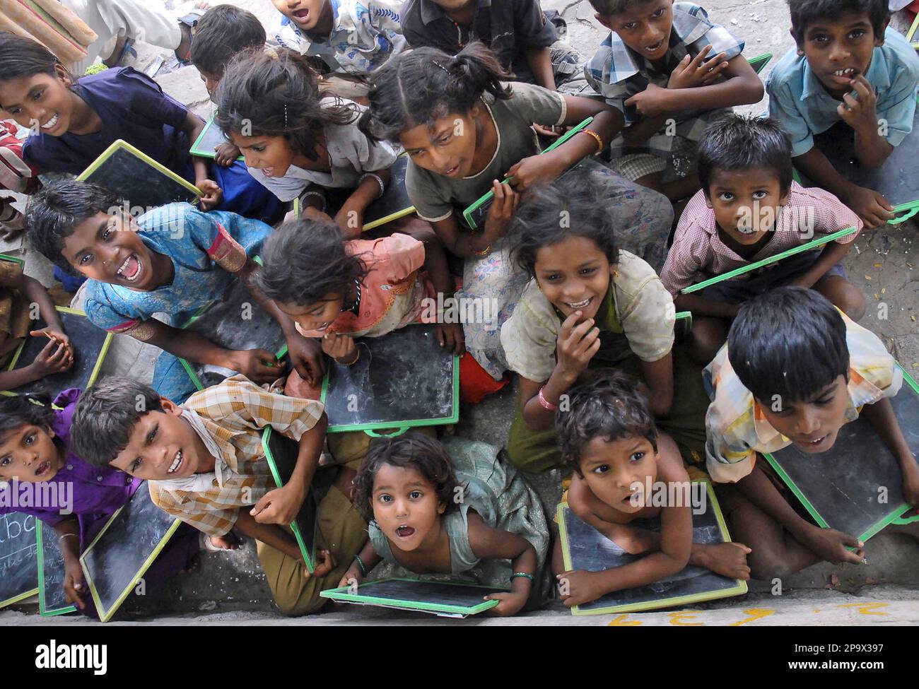 Children from a shanty area study at a roadside school in Hyderabad ...