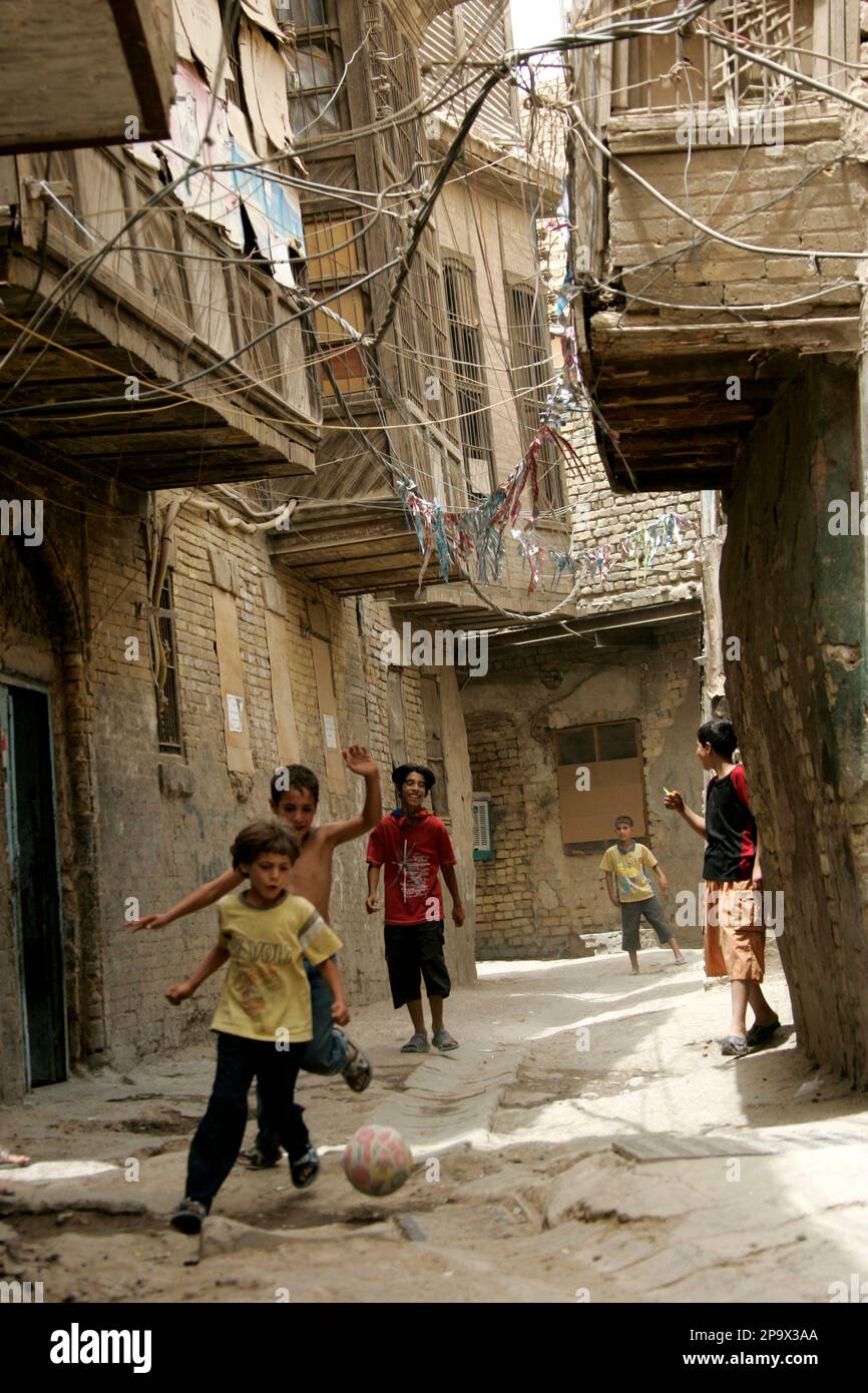 Children play soccer on a street in Baghdad's Fadhil neighborhood, Iraq ...