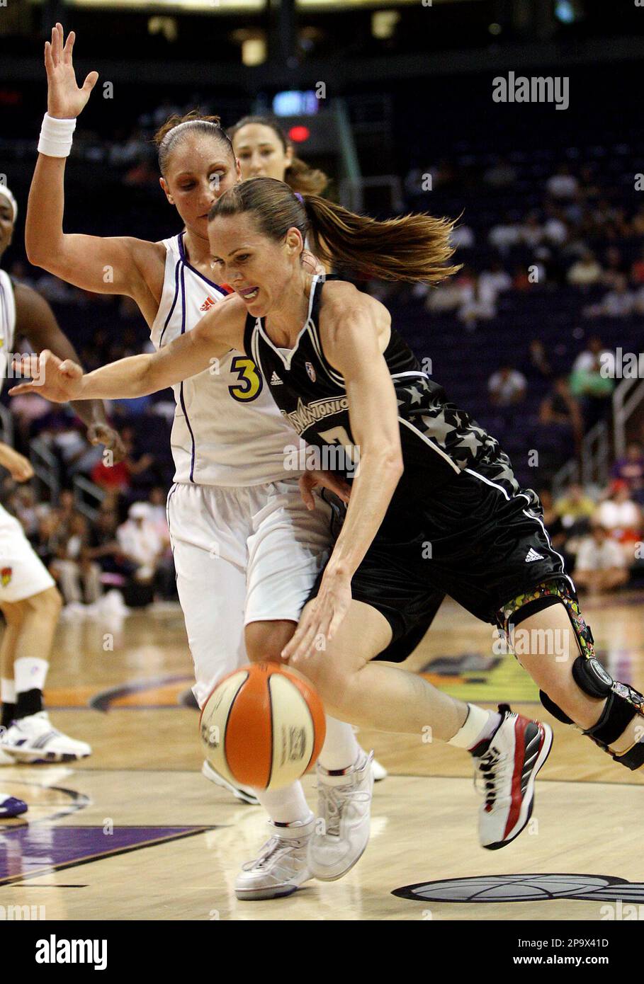 San Antonio Silver Stars' Erin Buescher, right, gets past Phoenix ...