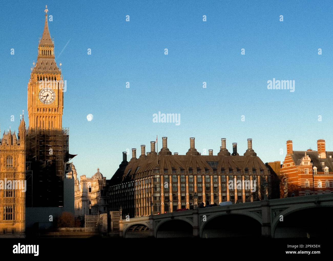 Big Ben at sunrise with the moon in the sky behind it. Maintenance has ...