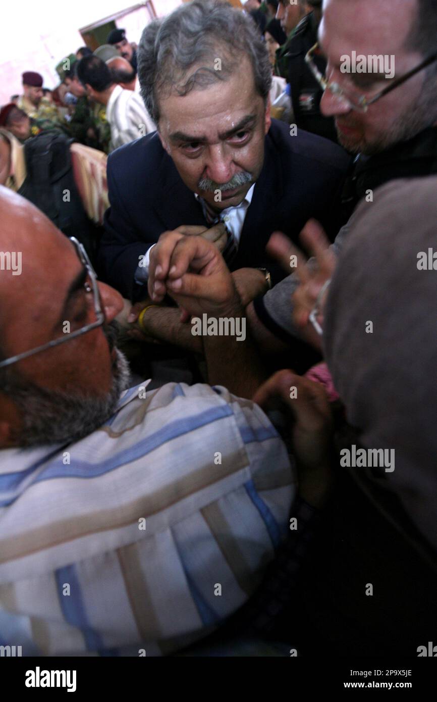 Iraqi lawmaker, Mithal al-Alousi, center, talks to internally displaced ...