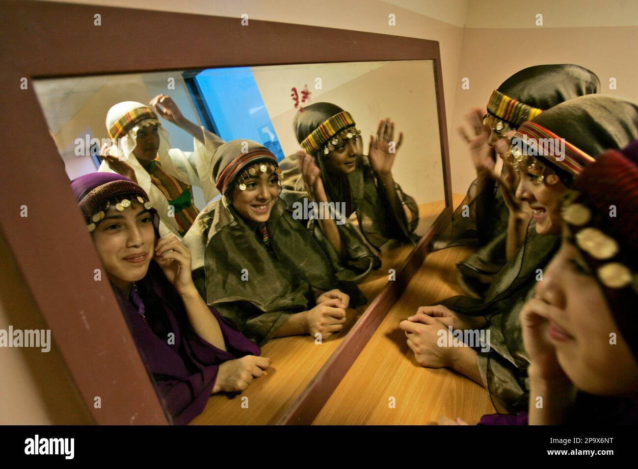 Young Palestinian dancers, wearing traditional clothes, prepare ...
