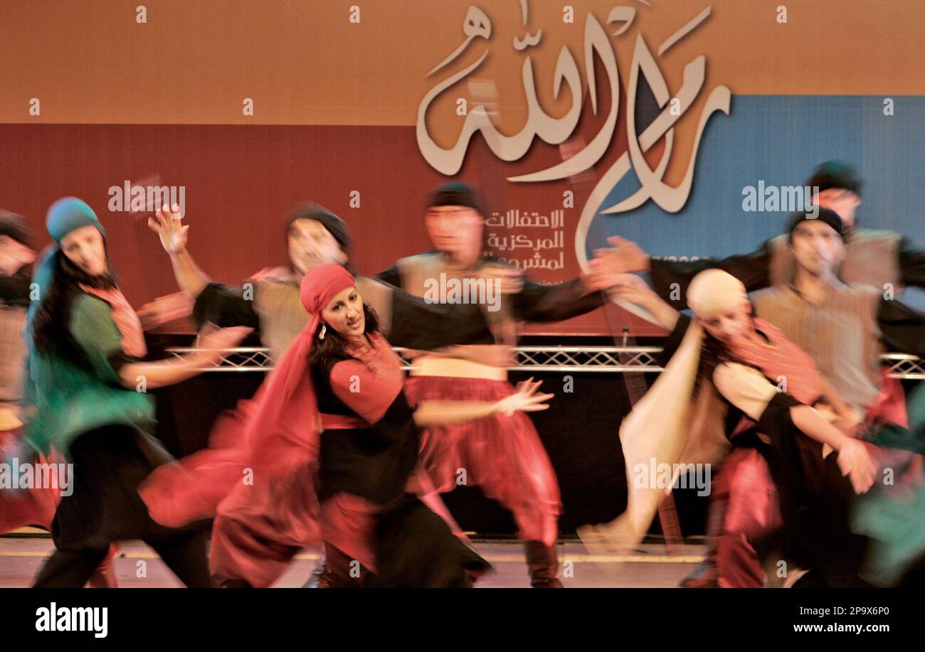 Palestinian dancers wearing traditional costume as they perform a folk ...