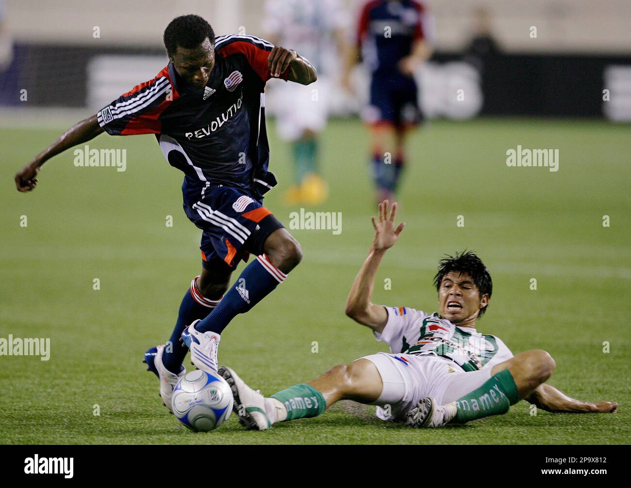 New England Revolution midfielder Sainey Nyassi, left, of Gambia, steps ...