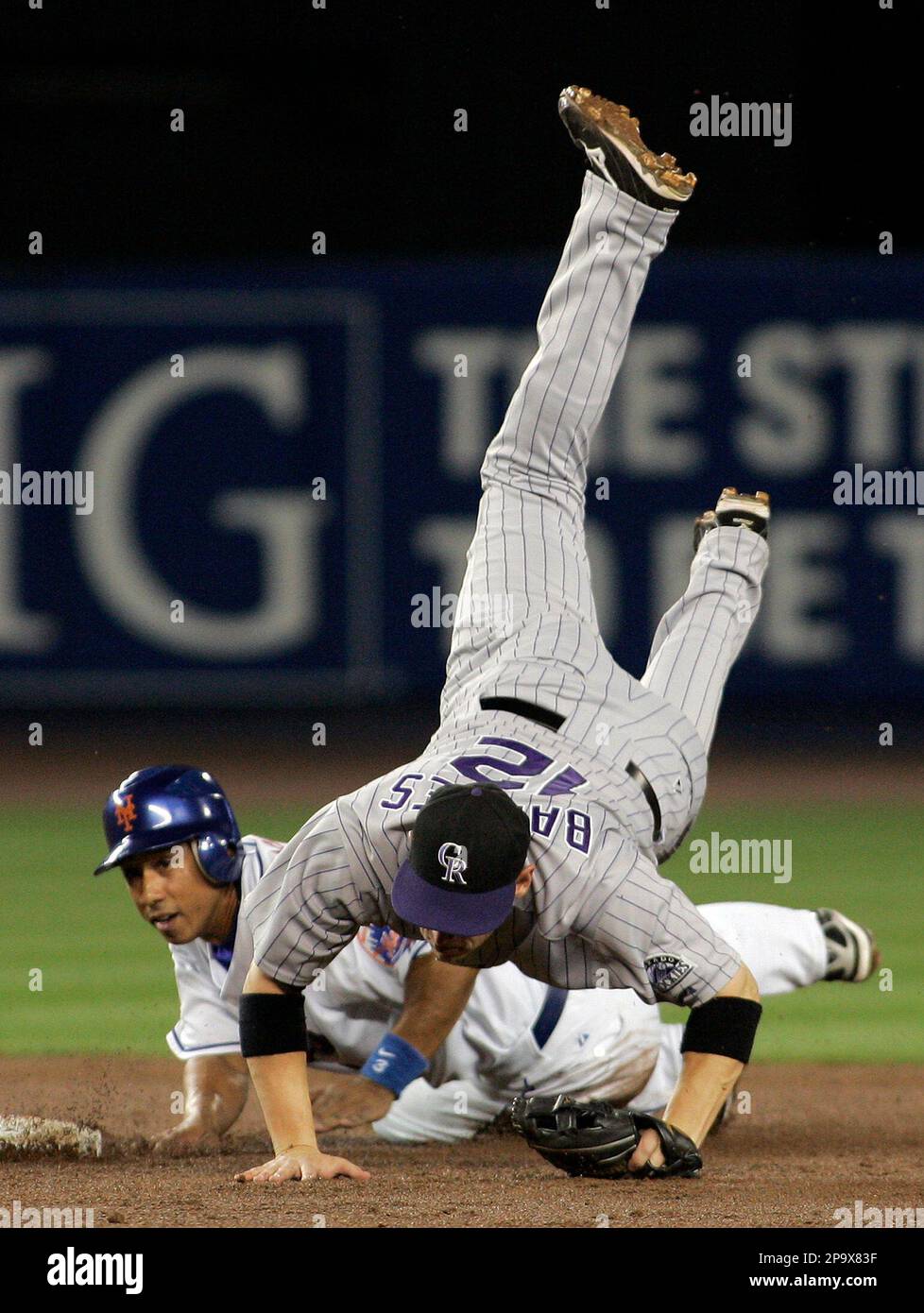 Colorado Rockies' Clint Barmes, front, lands on the ground after ...