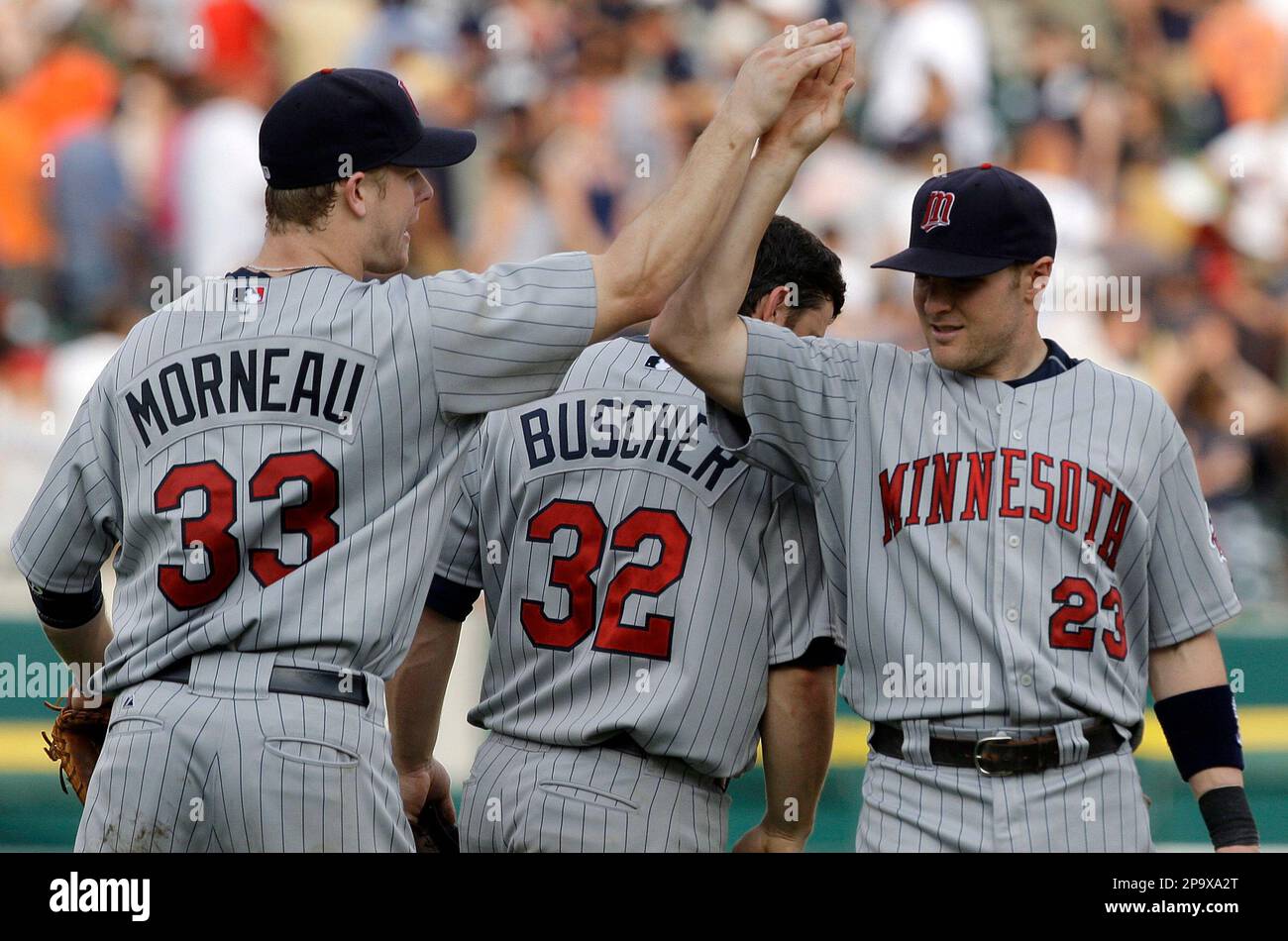 Minnesota Twins' Justin Morneau (33) congratulates Brendan Harris (23 ...