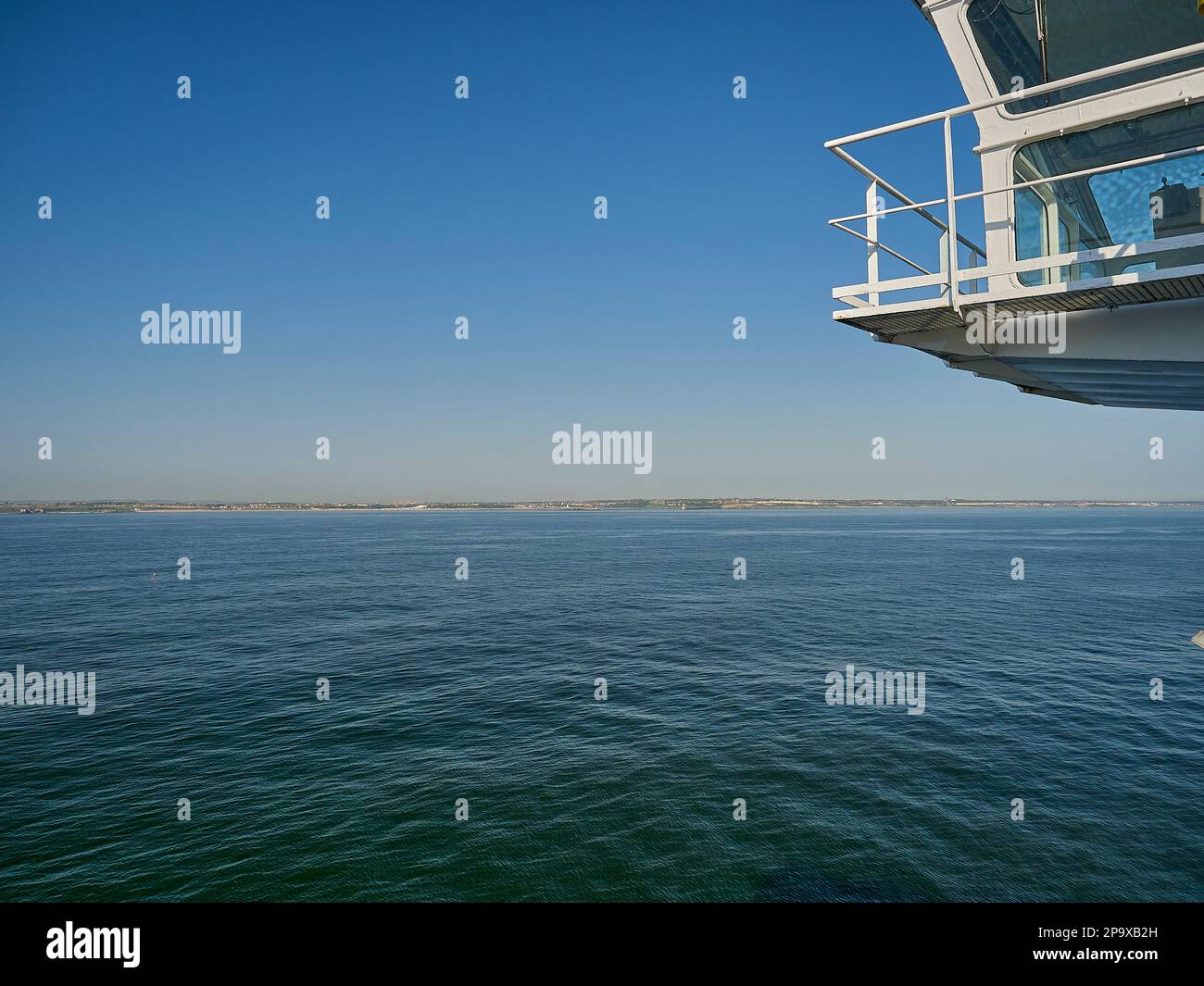 bridge of a ship driving over the open sea on a sunny day with clear ...