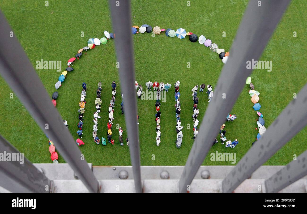 Amnesty International sympathizers stand together and form the word ...