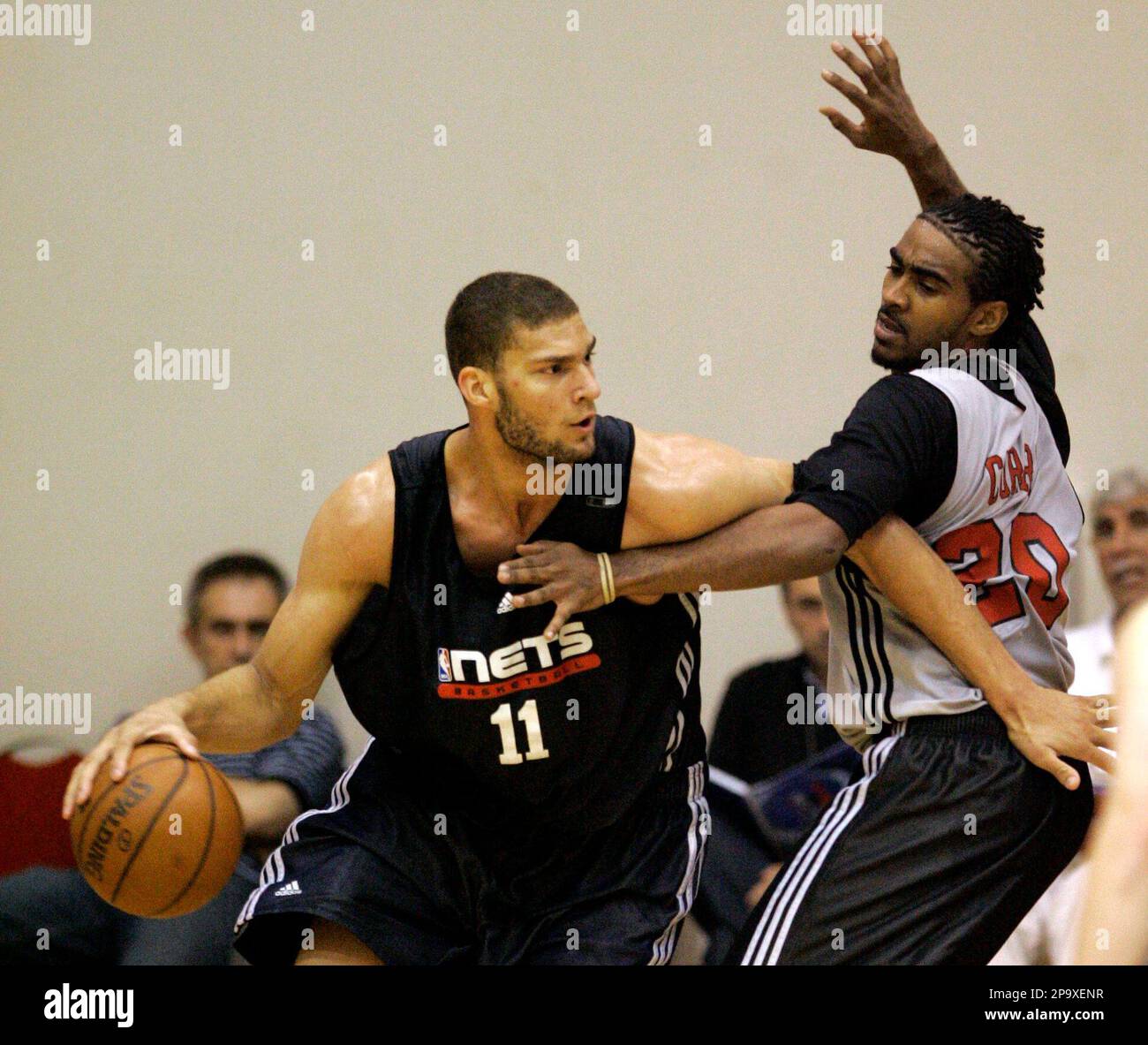 New Jersey Nets center Brook Lopez (11) works his way around Chicago ...