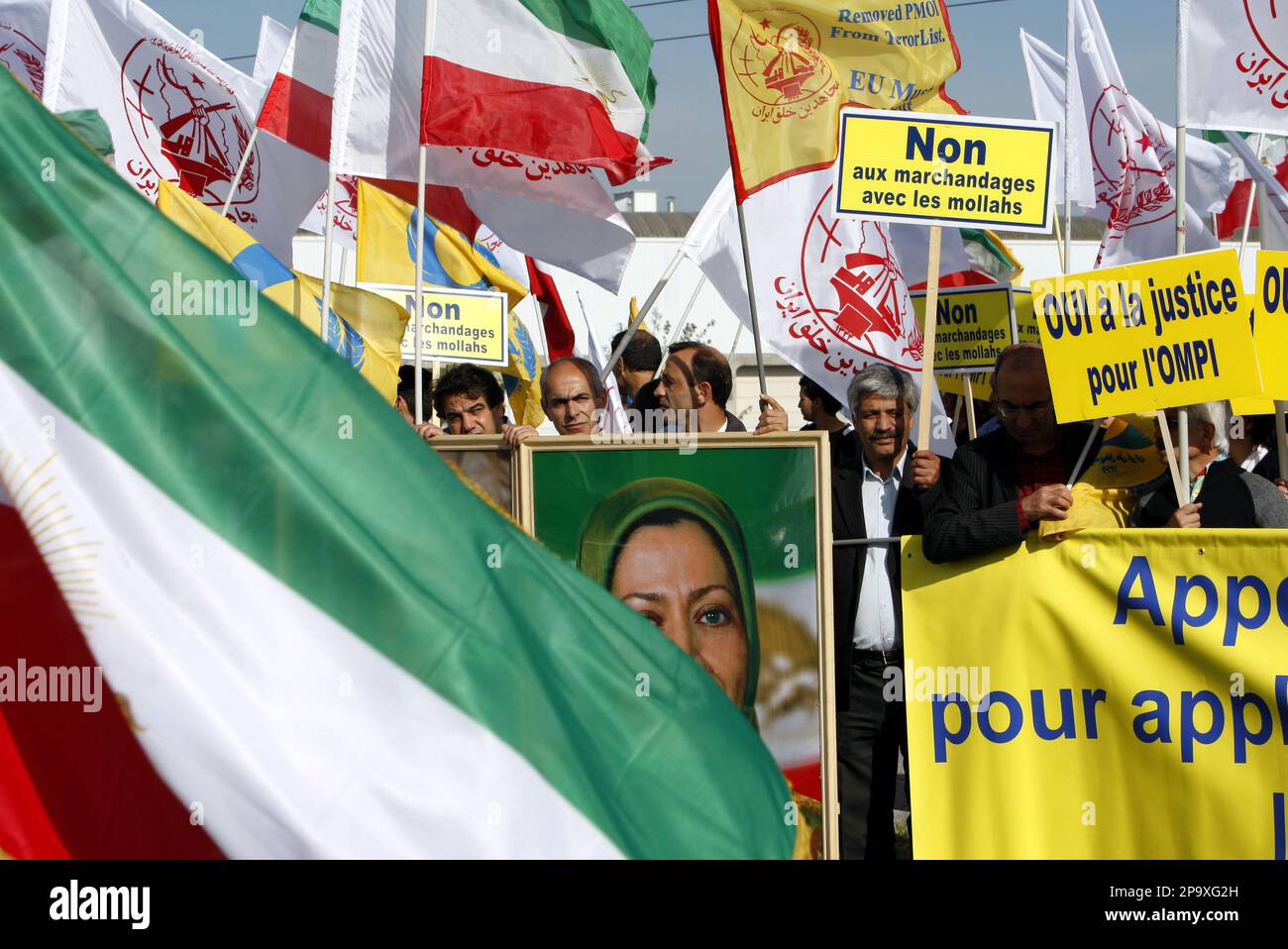 Iranian dissidents wave their national flag and various Islamic flags ...