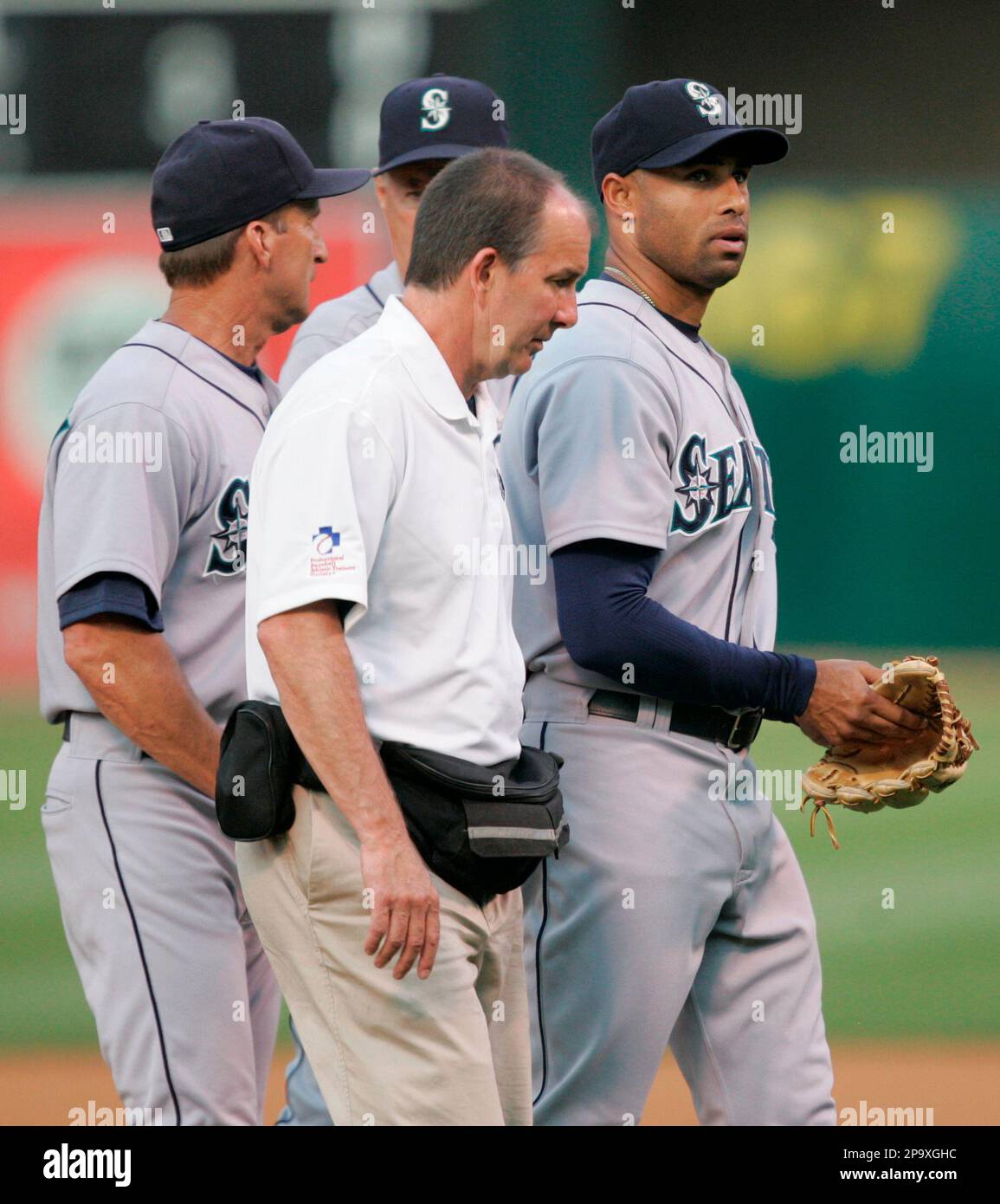 Seattle Mariners starting pitcher Miguel Batista, right, leaves the ...