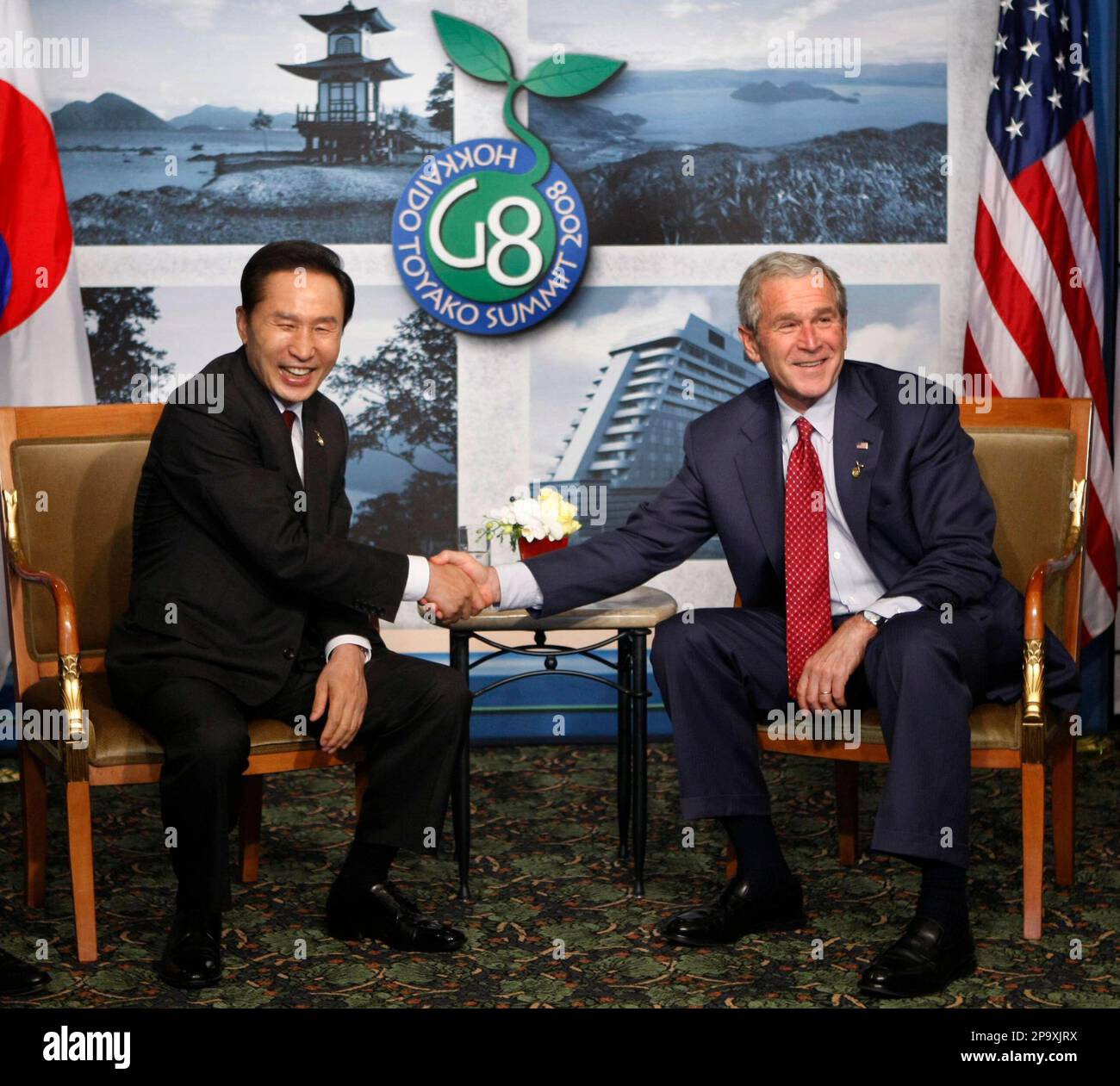 U.S. President George W. Bush, right, shakes hands with President of ...
