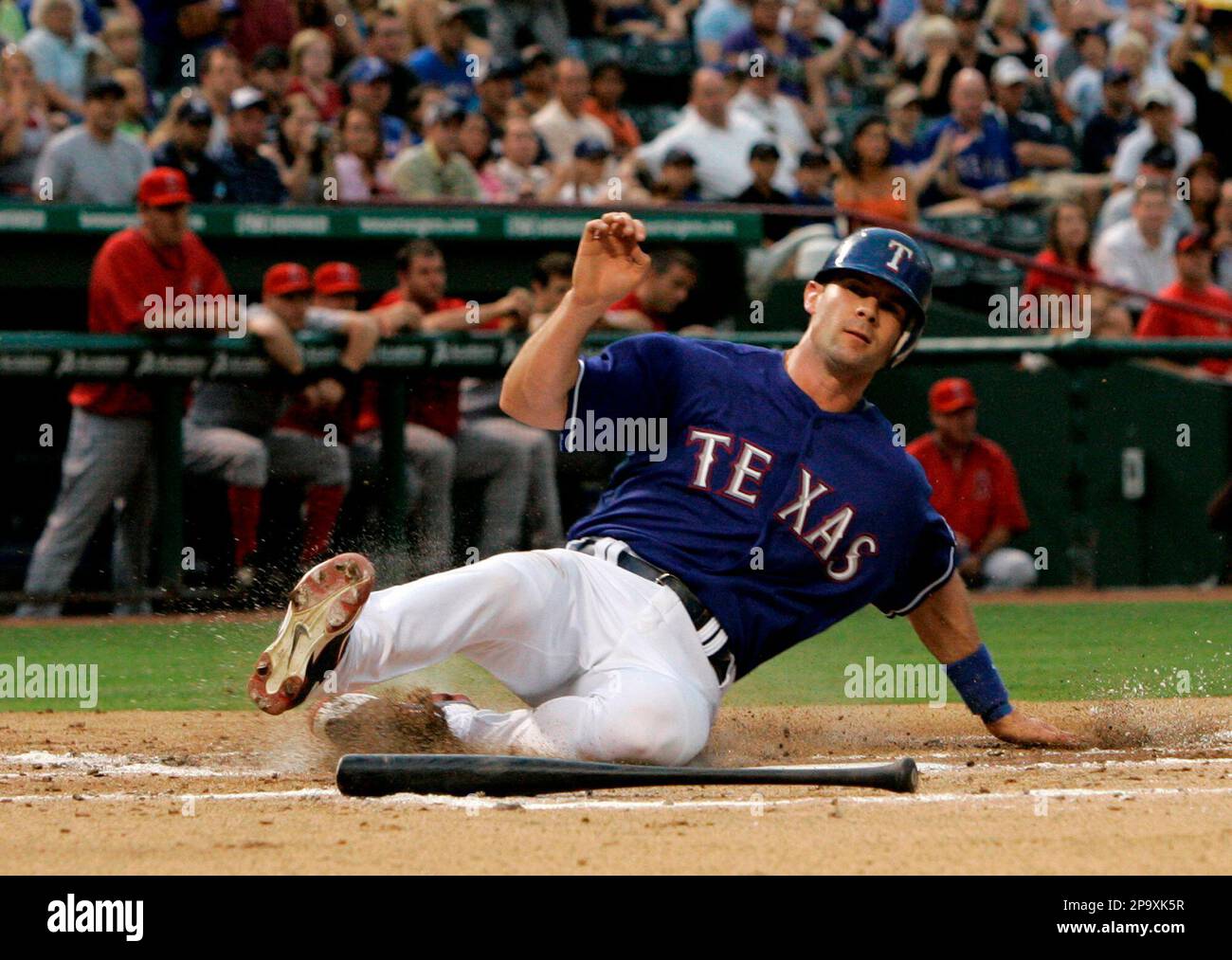 Texas Rangers' Michael Young scores on a sacrifice fly by Josh Hamilton ...