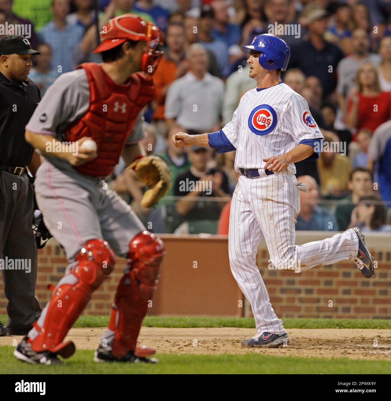 Chicago Cubs' Ryan Theriot, right, scores on a sacrifice fly by Aramis ...