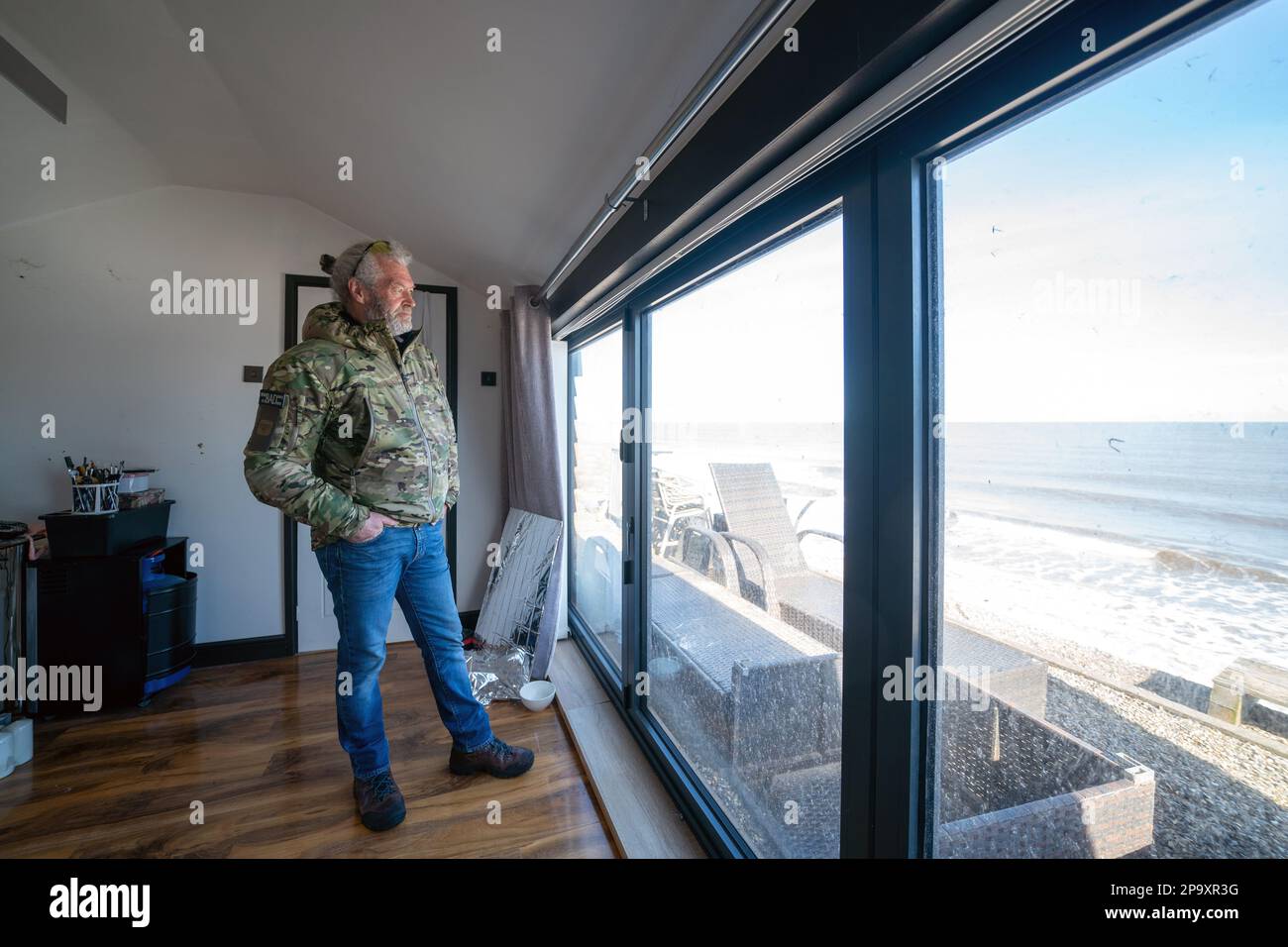 Hemsby resident Lance Martin looks out from his home on the cliff edge ...