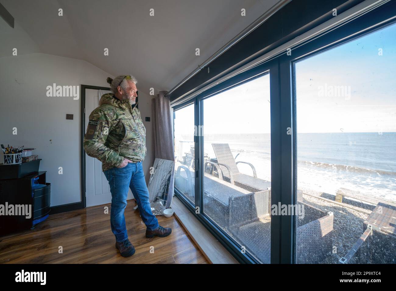 Hemsby resident Lance Martin looks out from his home on the cliff edge ...