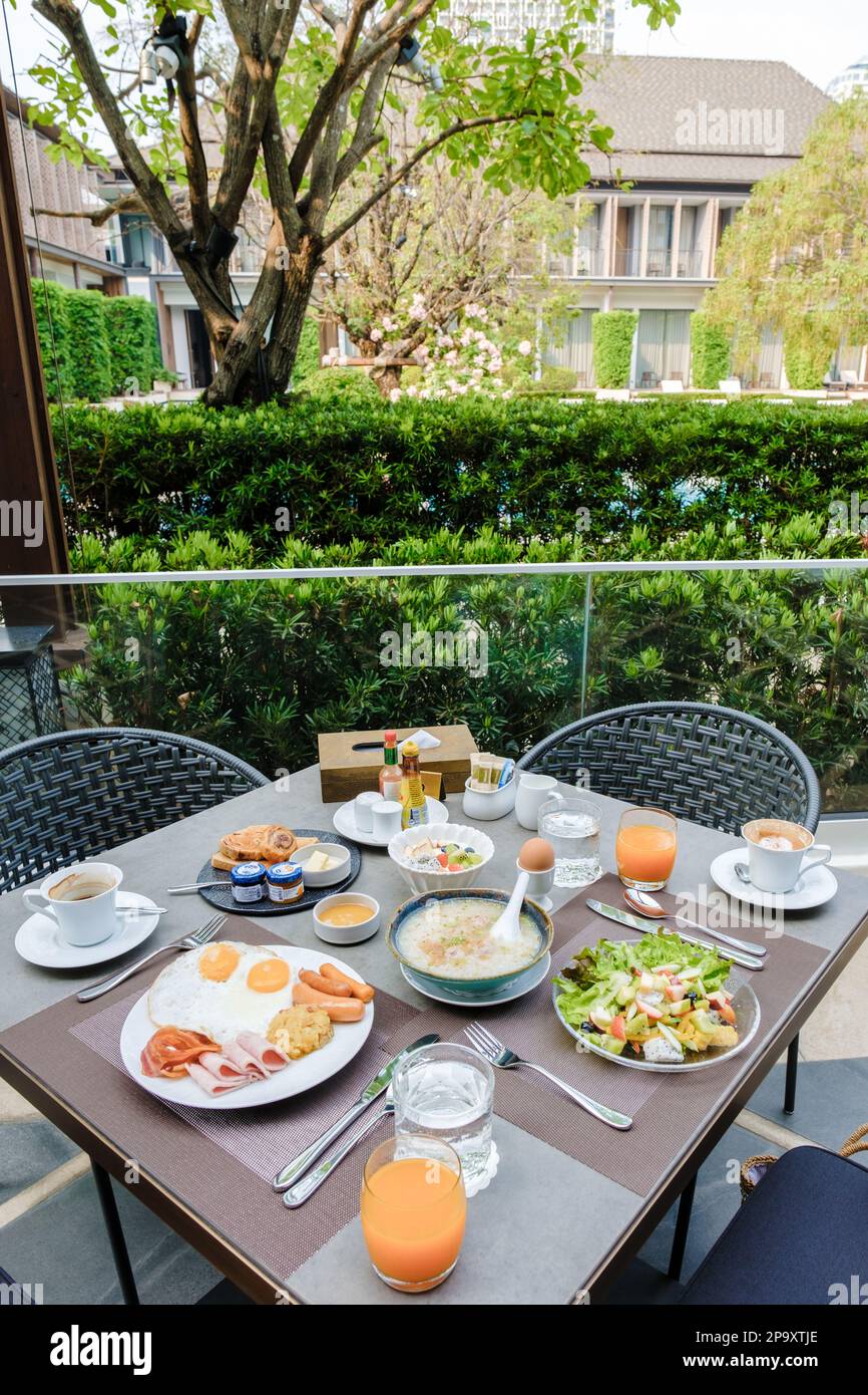 breakfast table at a luxury hotel with eggs bread and rice soup with ...
