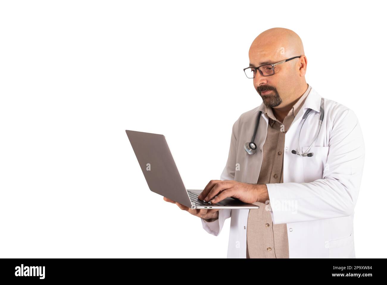 Physician using laptop. Isolated white background, copy space. Bald ...