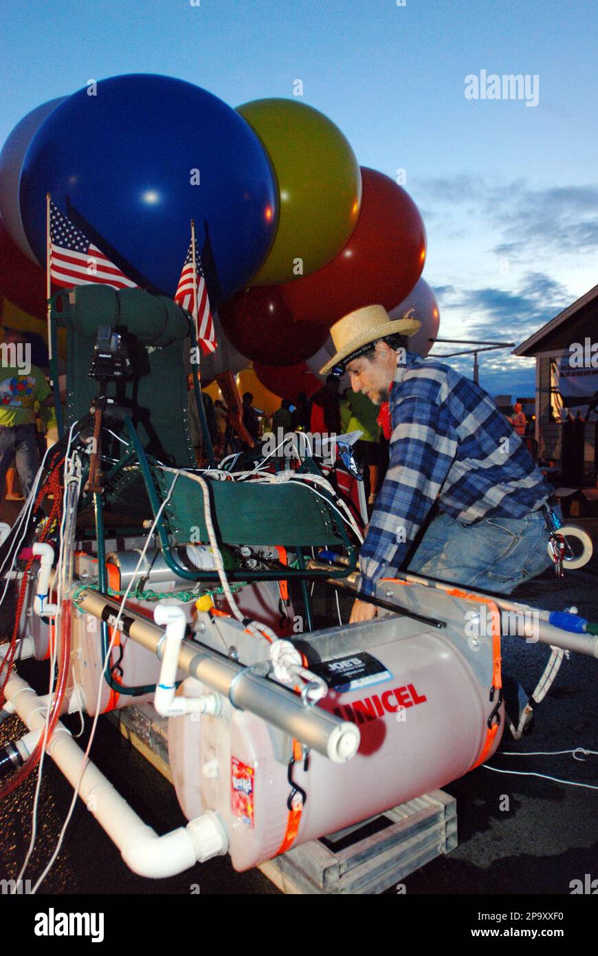 Head rigger Kimi Feuer makes final adjustments to Kent Couch's lawn ...
