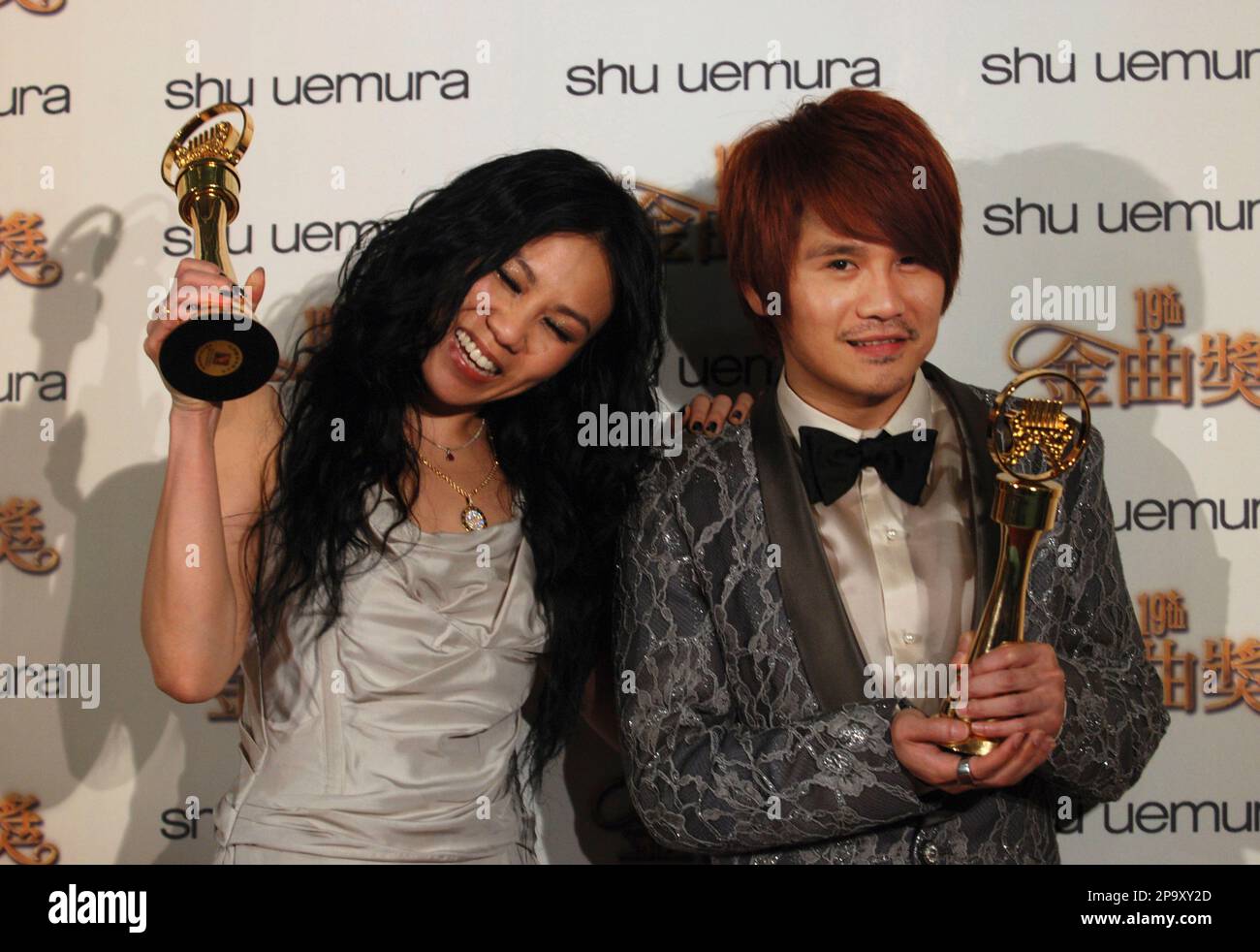 Singapore's Tanya Chua, left, holds awards for "Best Female Singer" and ...