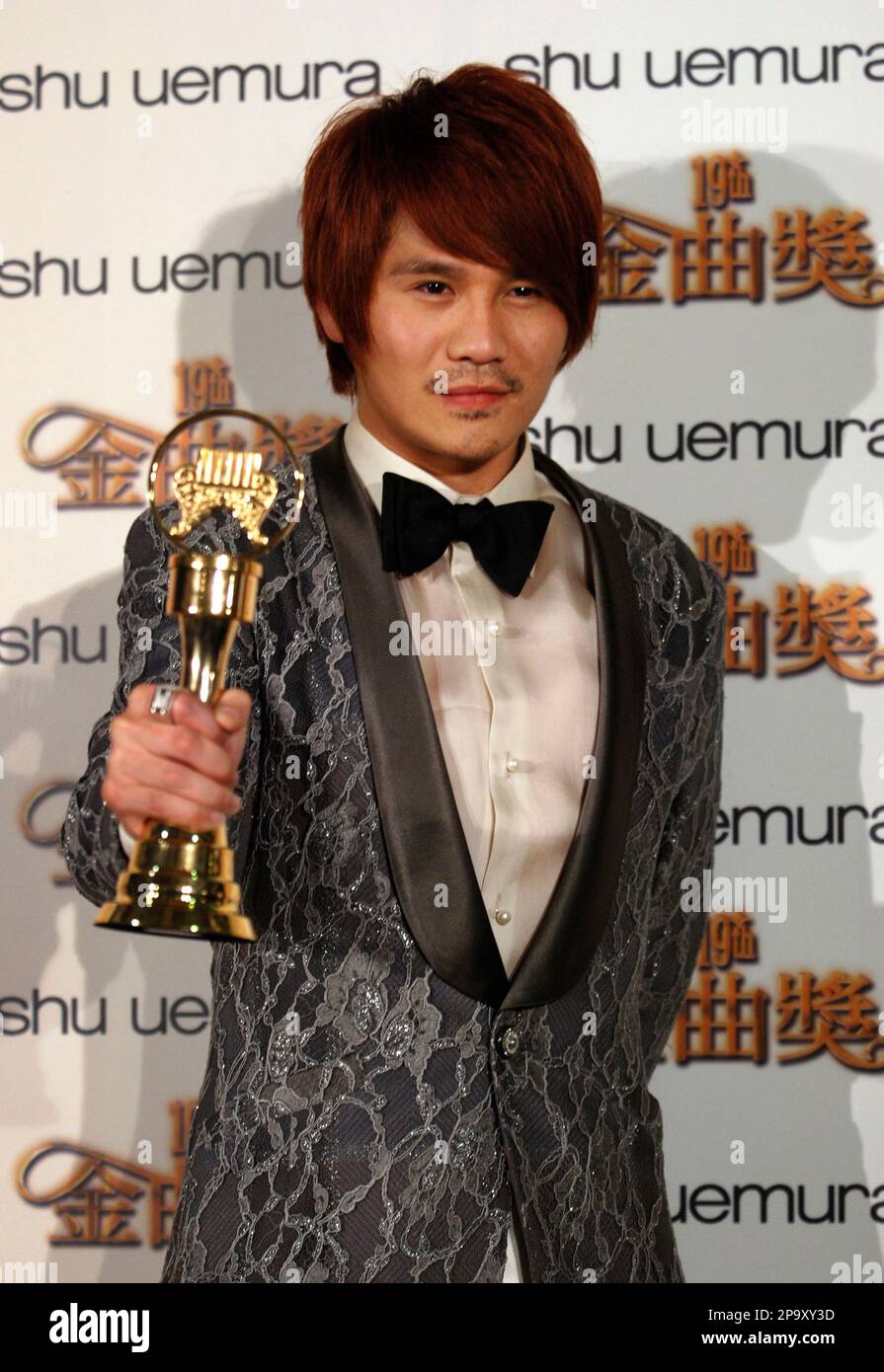 Malaysian singer Gary Cao holds his award for "Best Male Singer" at the ...