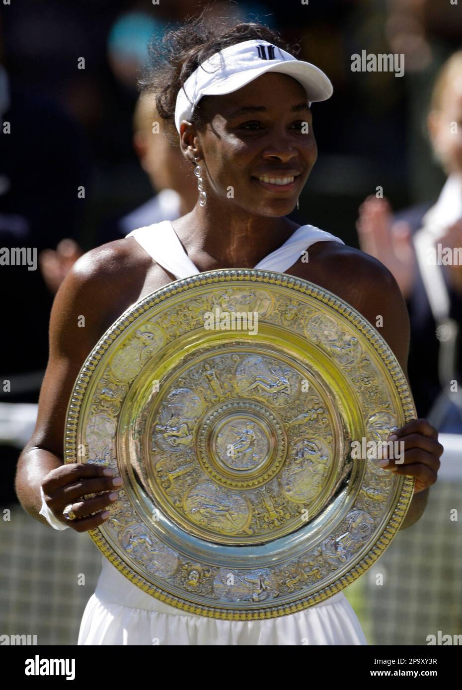 Venus Williams holds her trophy, after defeating her sister Serena to ...