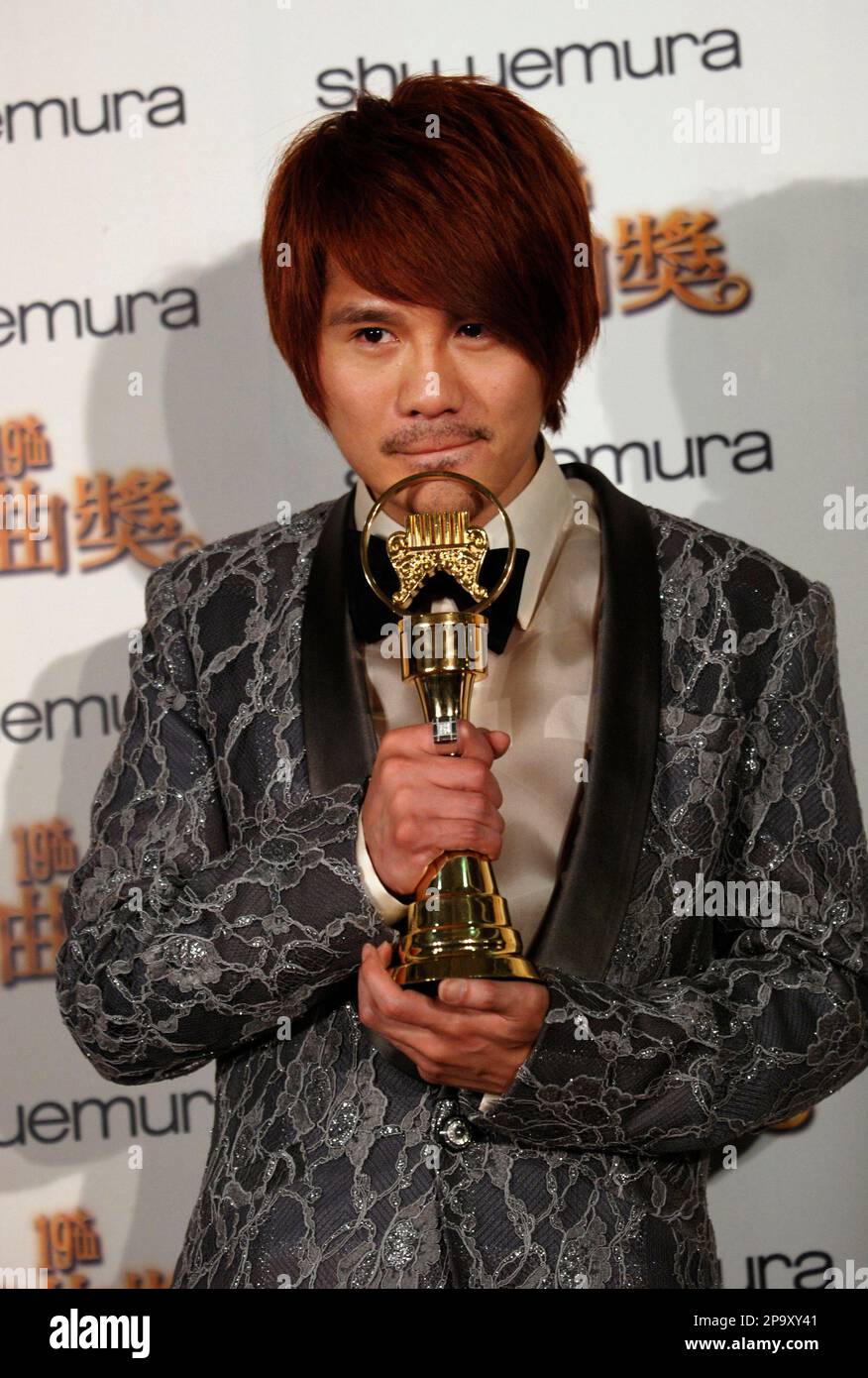 Malaysian singer Gary Cao holds his award for "Best Male Singer" at the ...