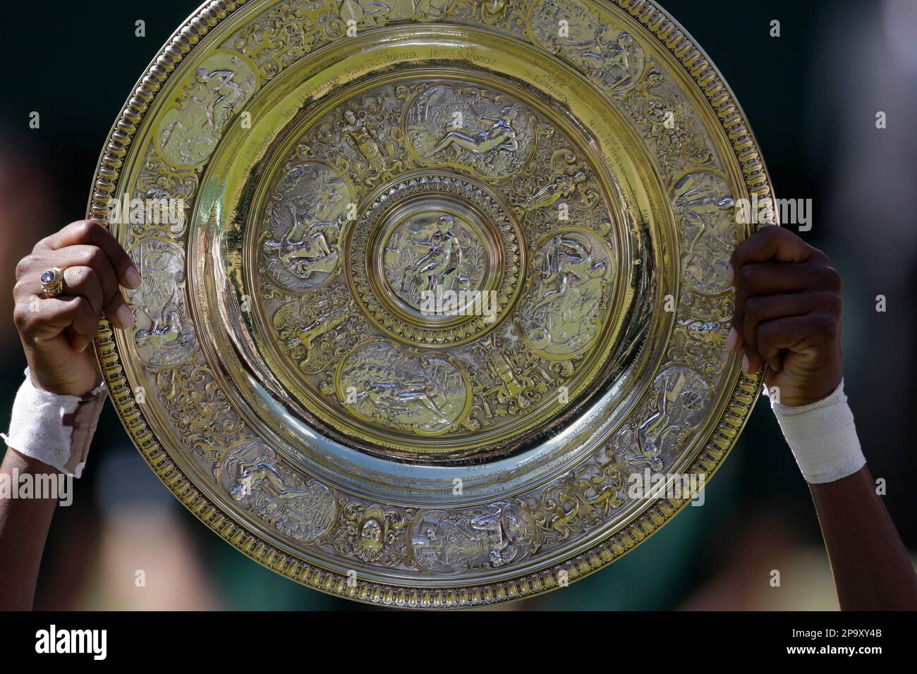 Venus Williams holds her trophy, after defeating her sister Serena to ...