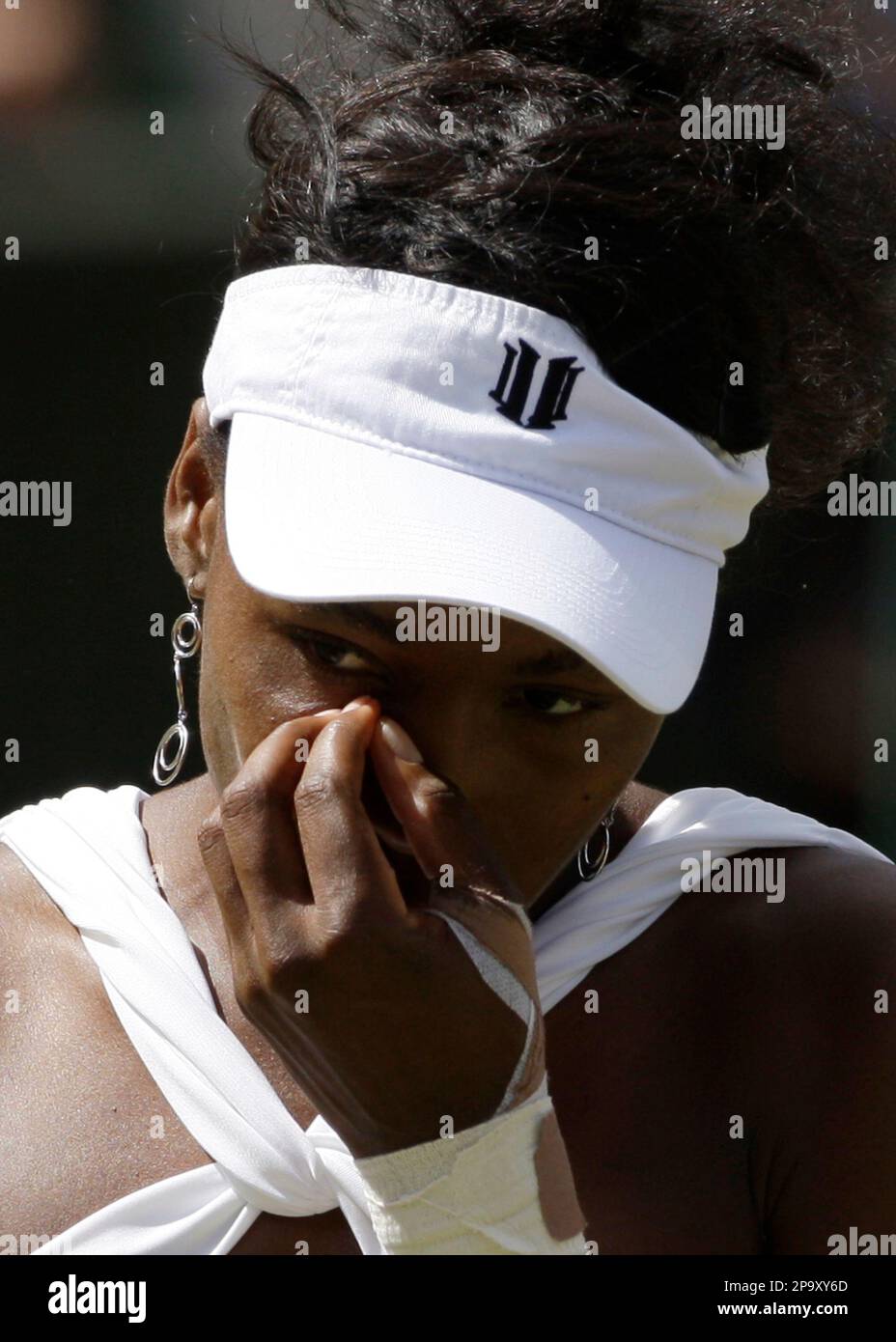 Venus Williams covers her face during the Women's Singles final against ...