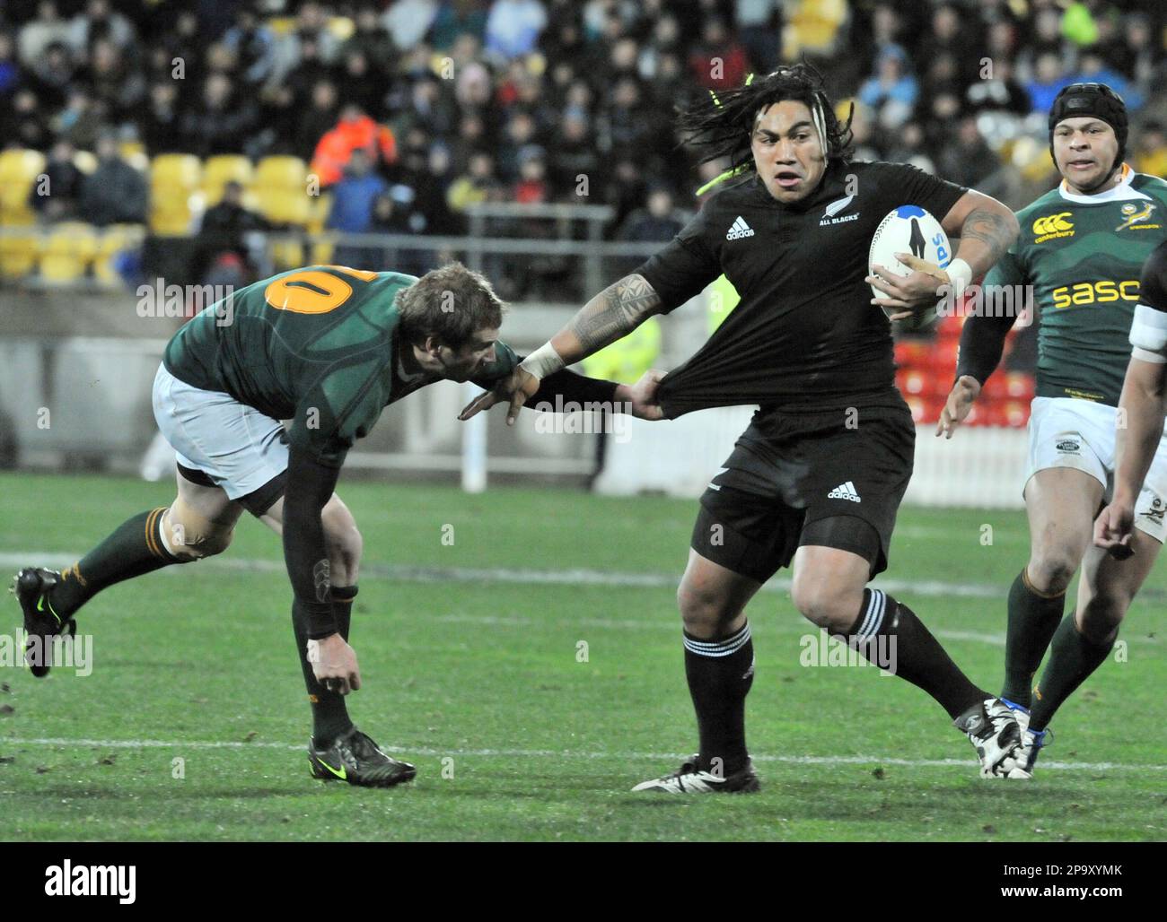 New Zealand All Blacks' Ma'a Nonu. right, is held by South Africa's ...