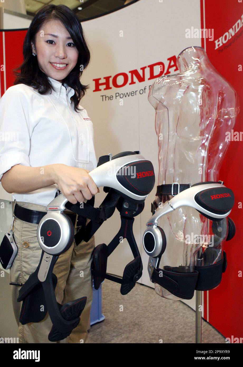 Chihiro Ogawa, an employee of a PR company, holds a prototype of Honda Motor Co.'s new walking ...