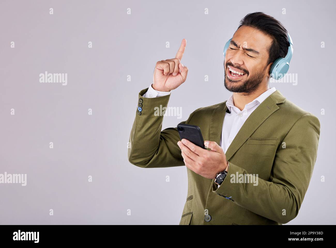 Business man, singing and headphones by studio background with phone ...