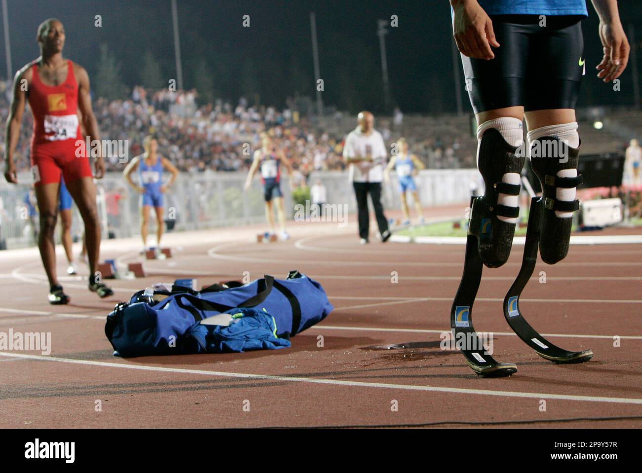 Double-amputee sprinter Oscar Pistorius, right, of South Africa, stands ...