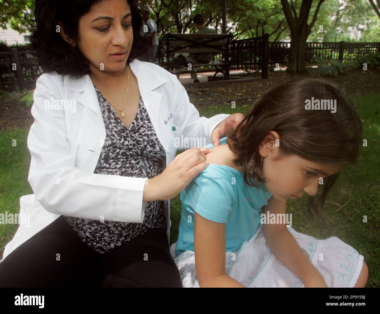 Dr. Anju Peters shows where a swarm of mosquitoes attacked her daughter ...