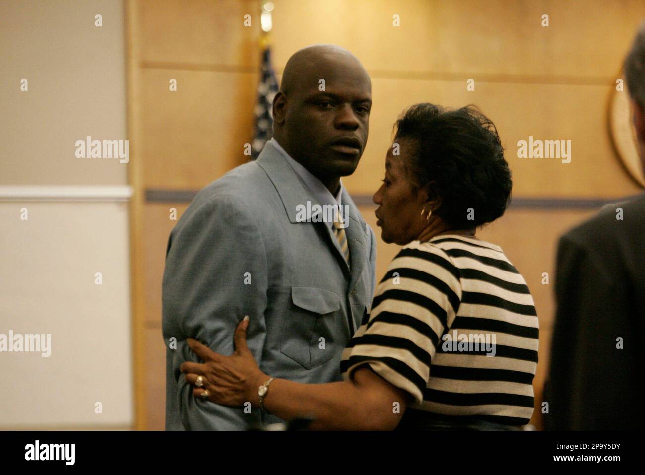 Former San Diego Chargers football player Steve Foley is held by his ...