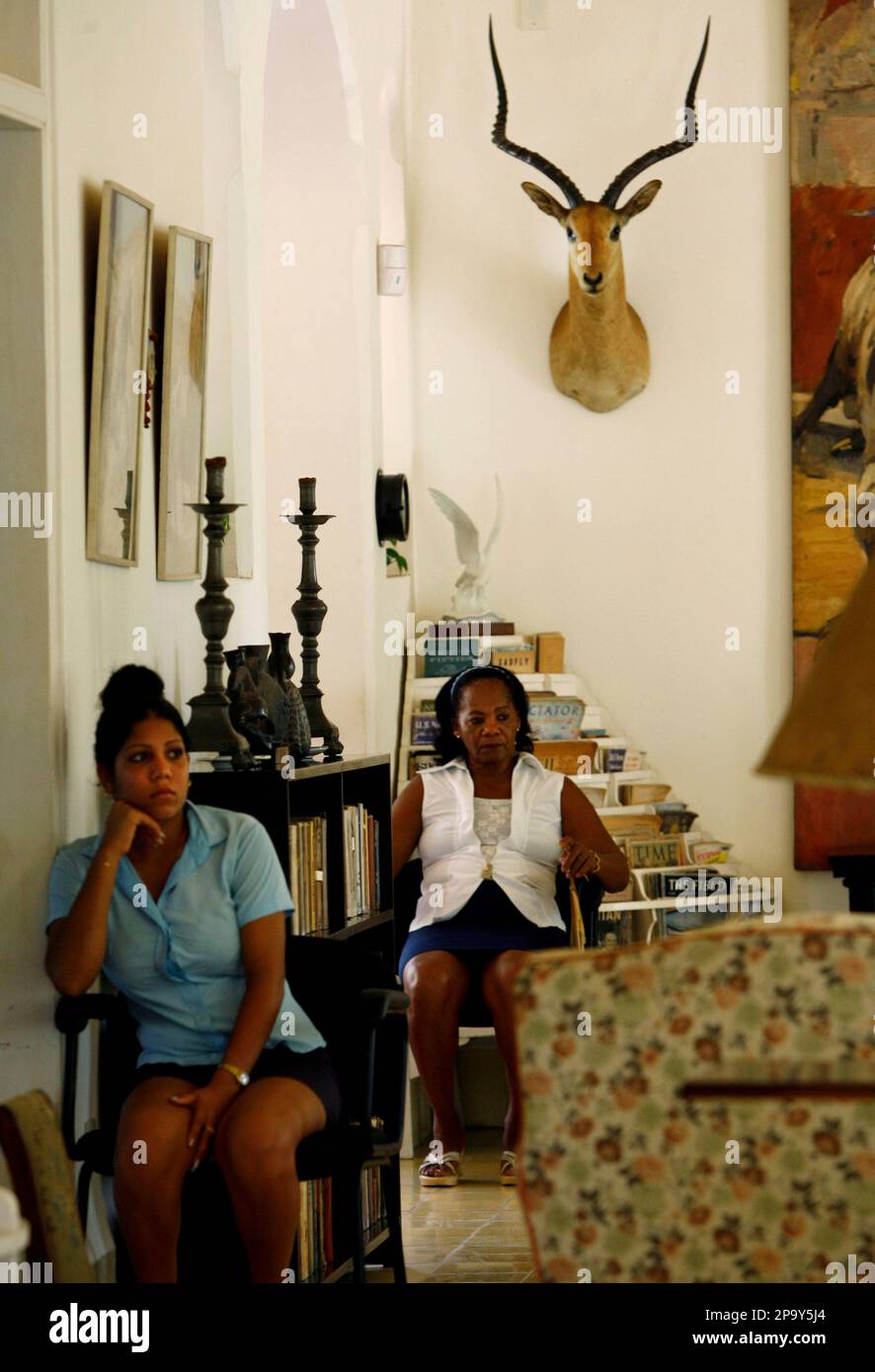 Workers sit in the former home of late American writer Ernest Hemingway ...