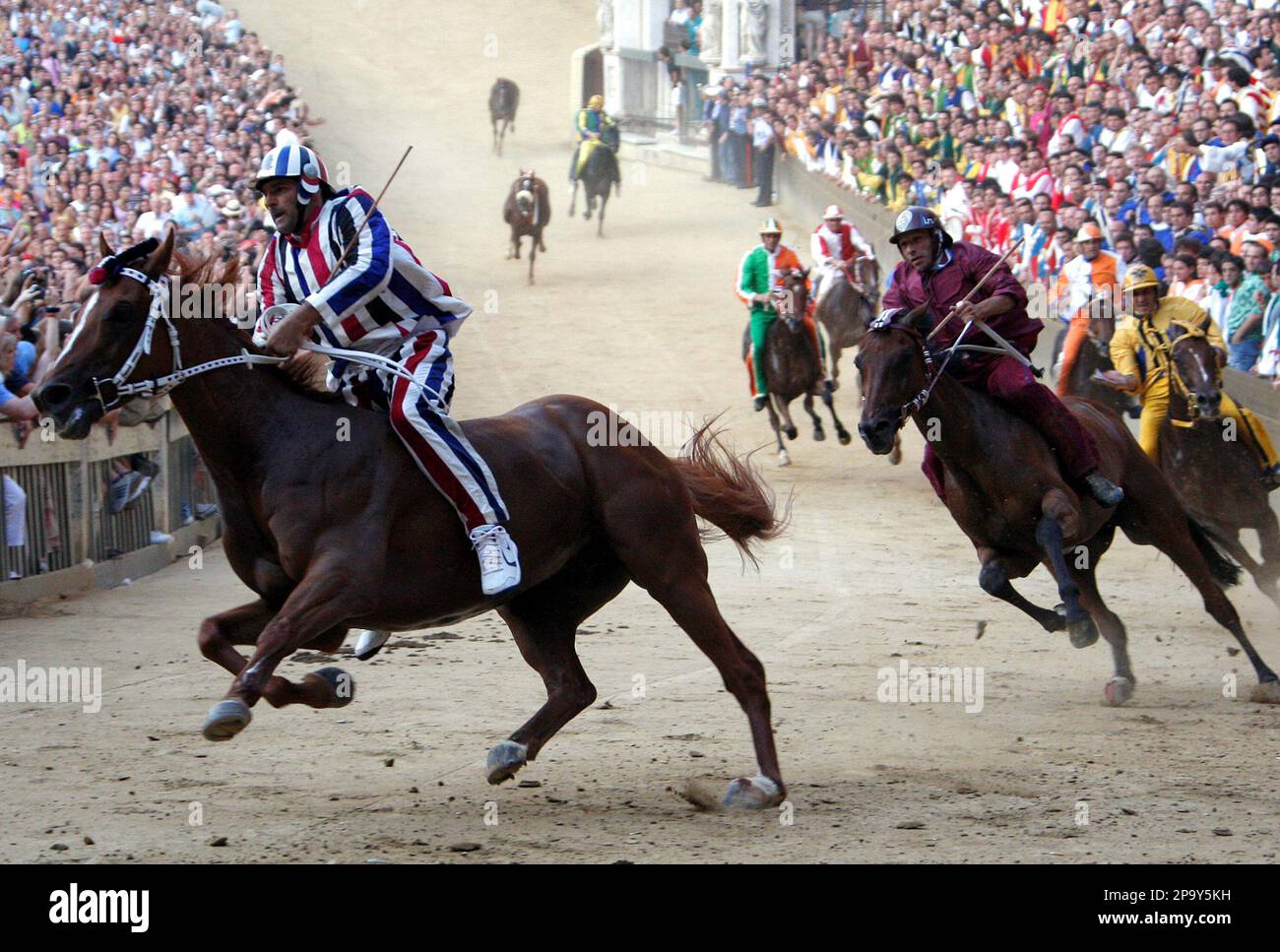 A view of horses galloping on, during the Palio horse race in Siena ...