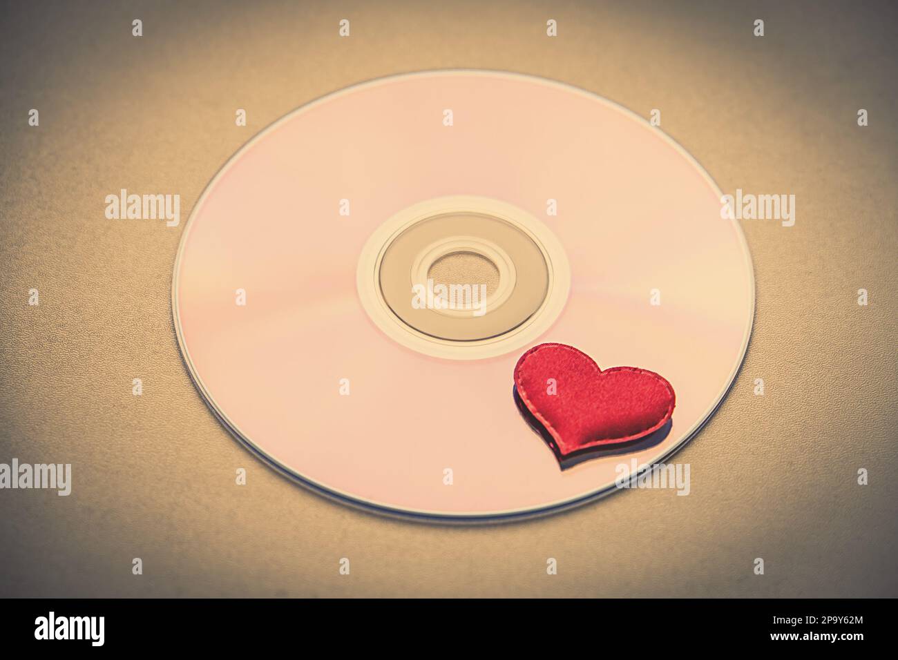 Toned Photo of CD Disk with a Red Heart closeup Stock Photo - Alamy