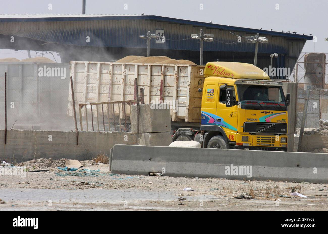 A Palestinian truck loaded with wheat, drives into the Palestinian side ...