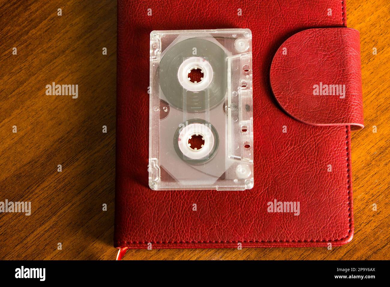 Red Book with the Audio Tape Cassette on the Wooden Table closeup Stock ...