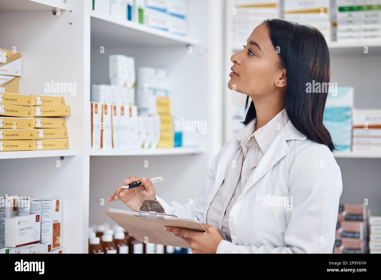 Pharmacy stock check, Indian woman and checklist of medicine and pills ...