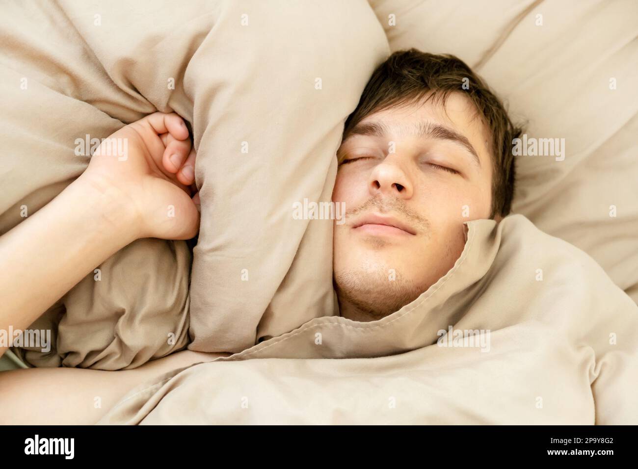 Young Man sleeping in the Bed at the Home closeup Stock Photo - Alamy