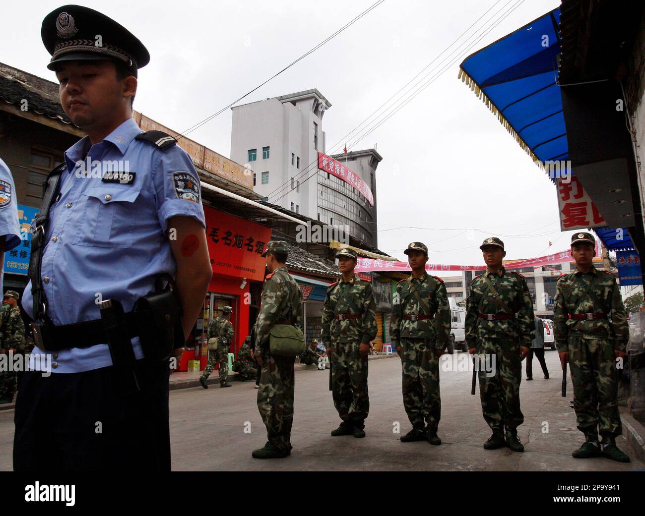 Chinese police and paramilitary police officers stand guard at the ...