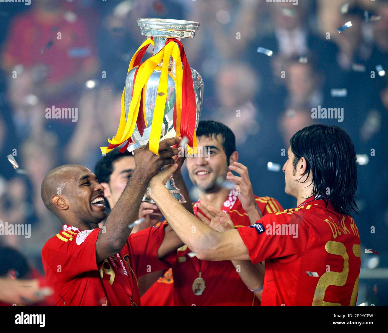 Spain's Marcos Senna, left, and Ruben de la Red, right, hold up the ...