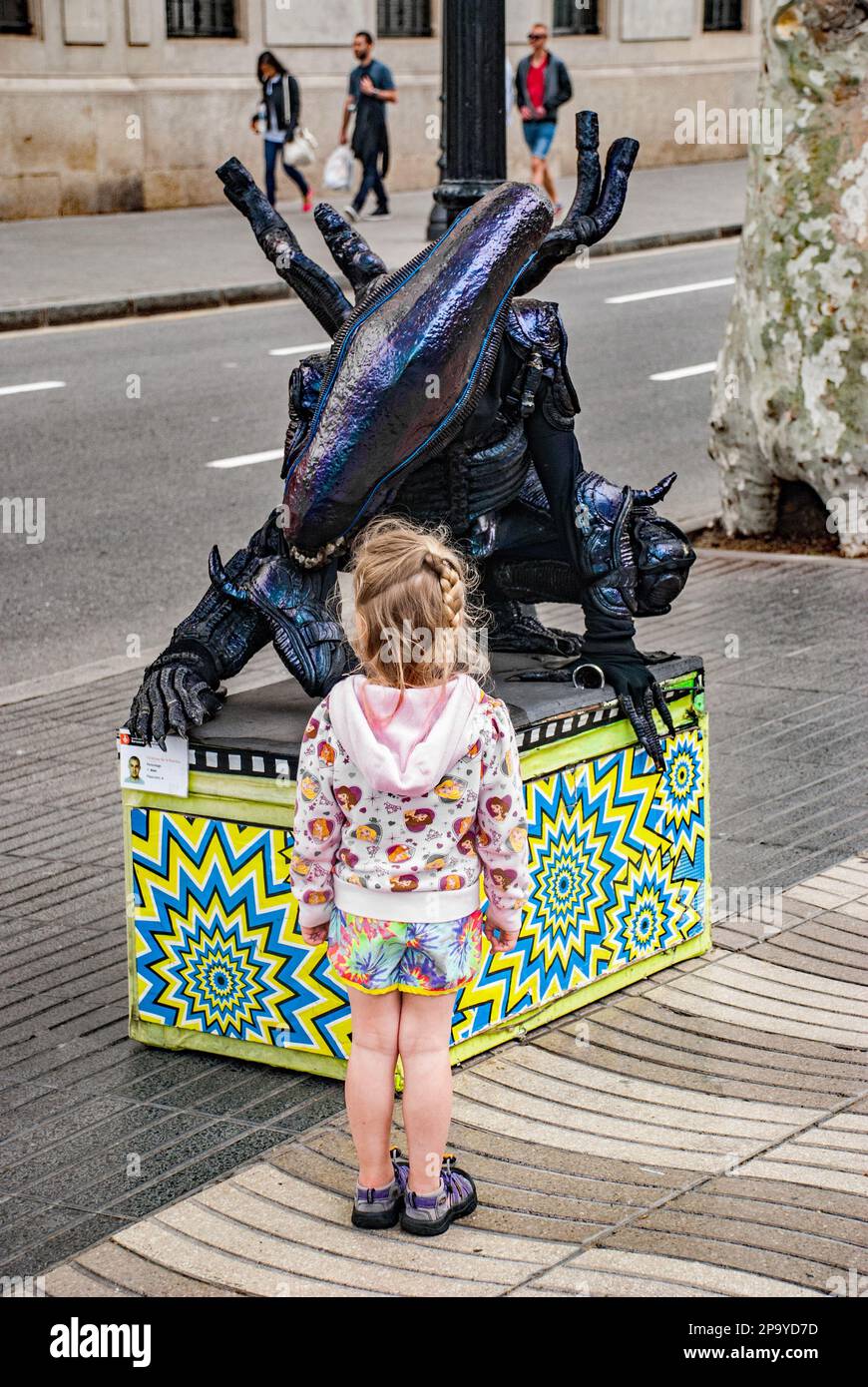Alien sculpture in La Rambla area of Barcelona being studied by a child ...