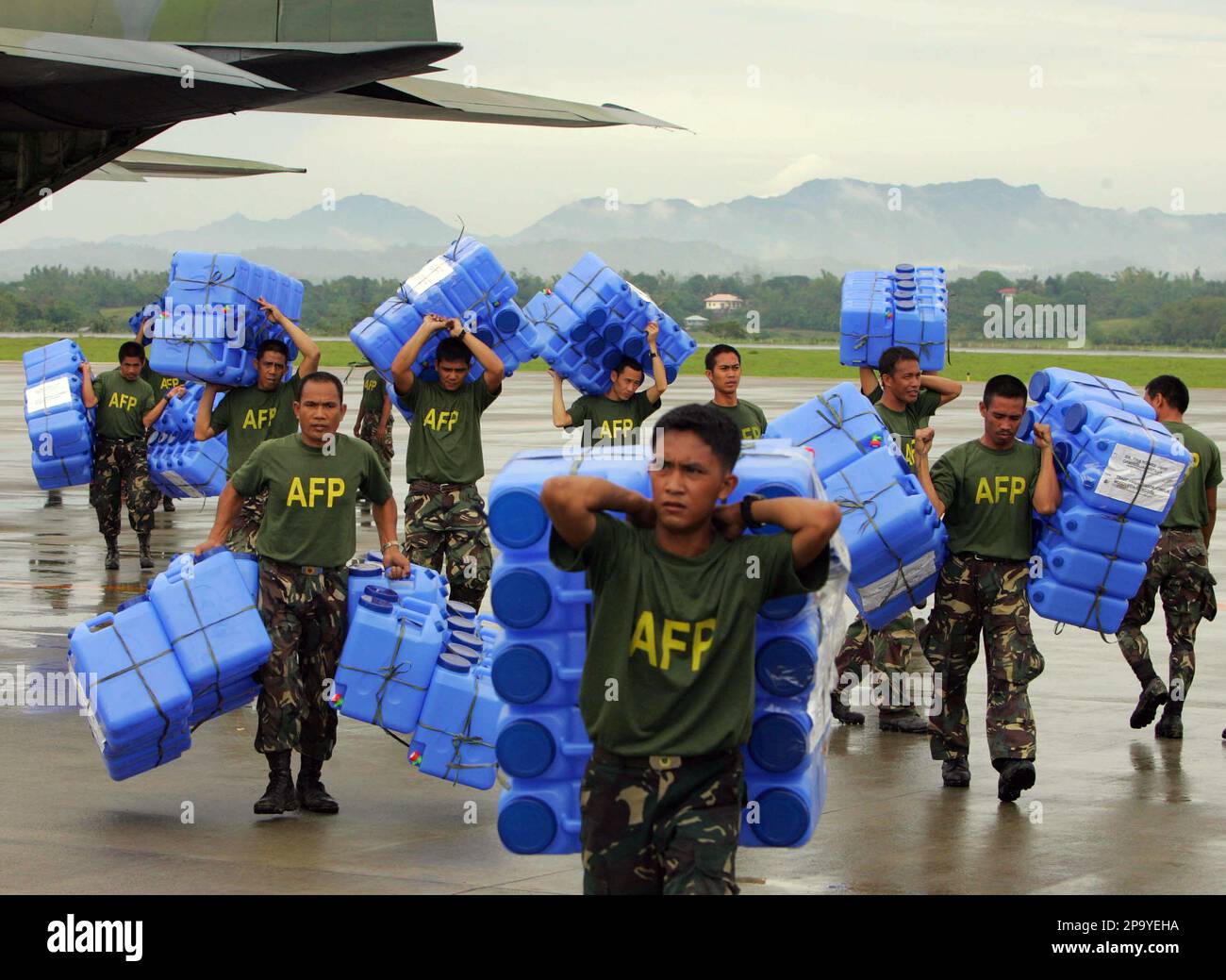 Philippine Army soldiers unload empty water containers for distribution ...