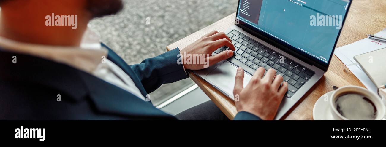 Young developer programmer freelancer in glasses working on project in ...